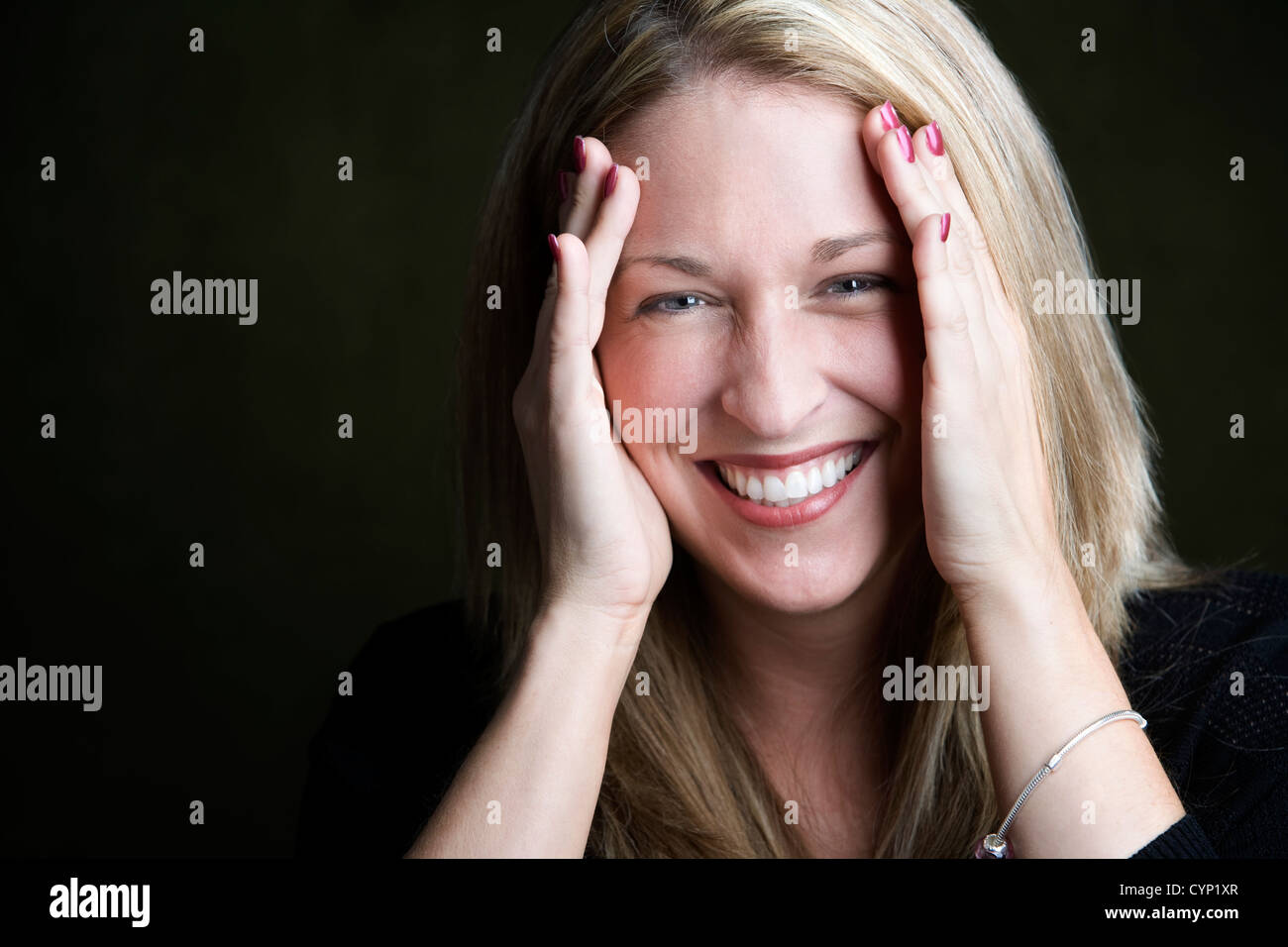Portrait of pretty blonde laughing woman on a dark background Stock ...