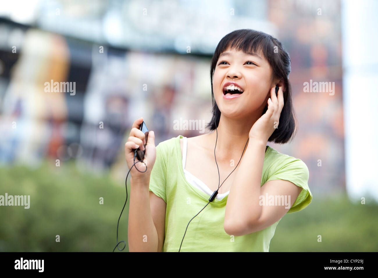 Schoolgirl listening to MP3 player Stock Photo - Alamy