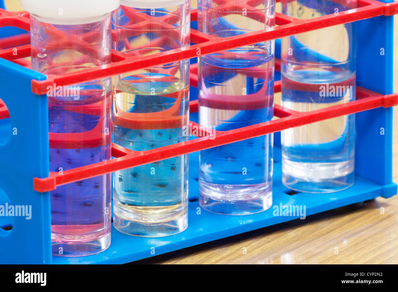 Test tubes with different colored chemicals in a plastic support Stock ...