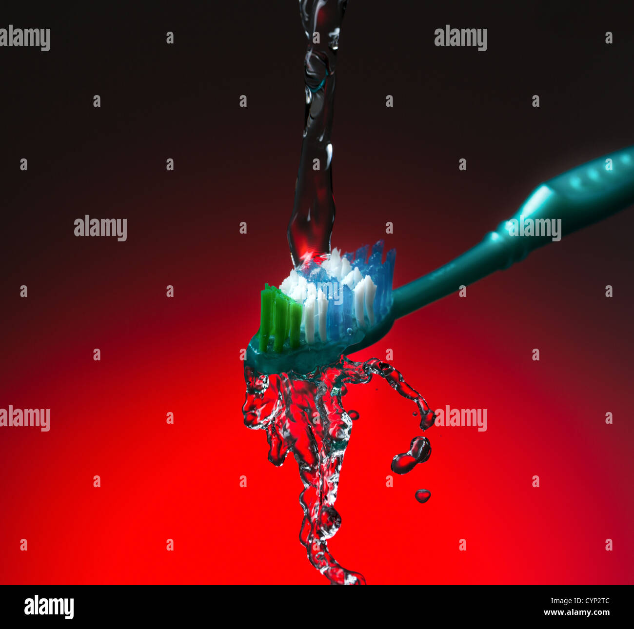 Toothbrush under stream of water Stock Photo - Alamy