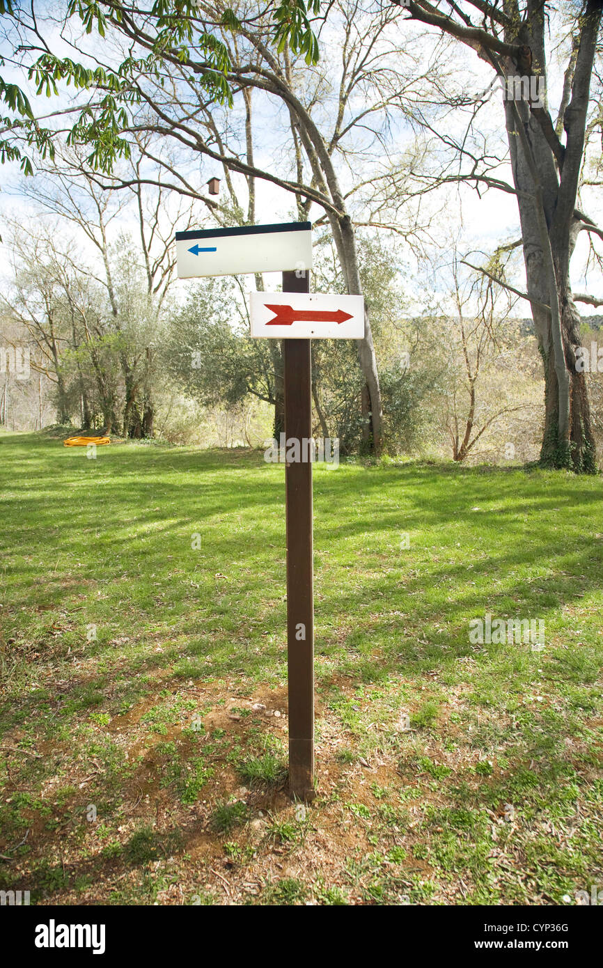 direction sign with an arrow at a spanish path Stock Photo - Alamy