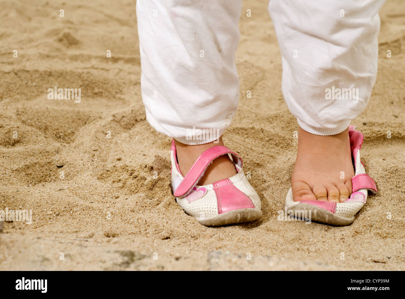Children take off her shoes on sand prepare to play Stock Photo - Alamy
