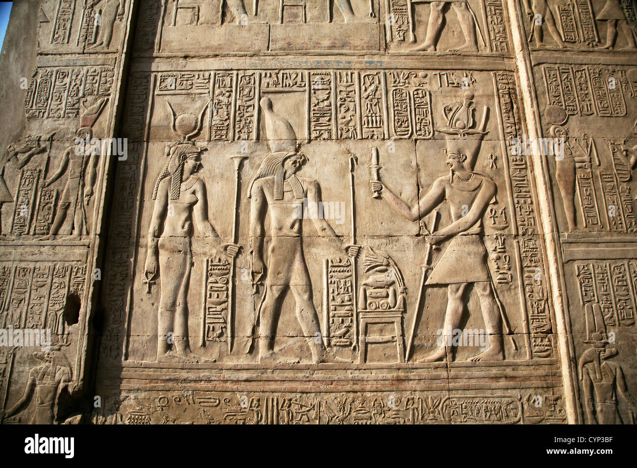 relief on a egyptian wall with a god a pharaoh an his wife Stock Photo ...