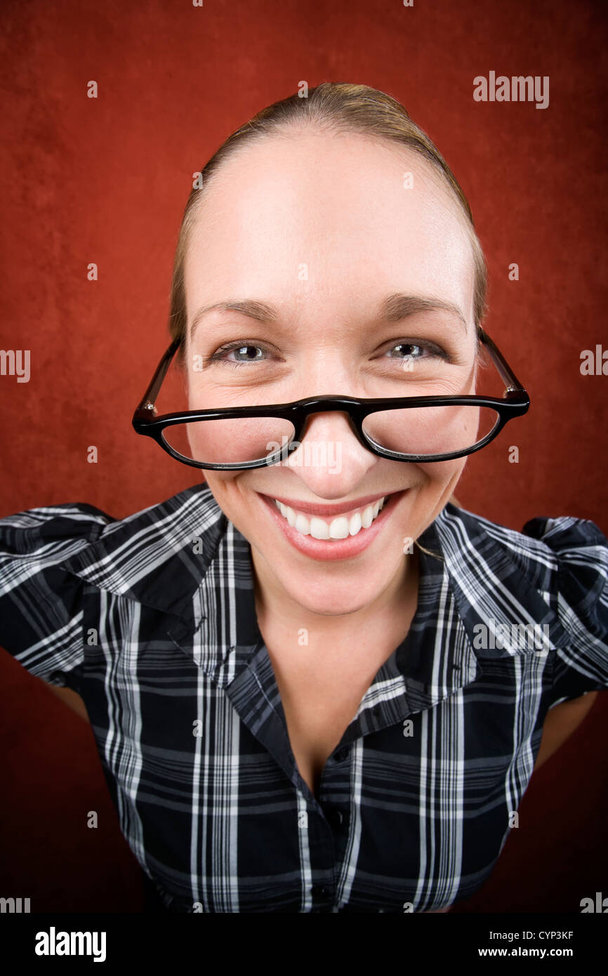 Pretty nerd woman in plaid bluse and glasses Stock Photo - Alamy