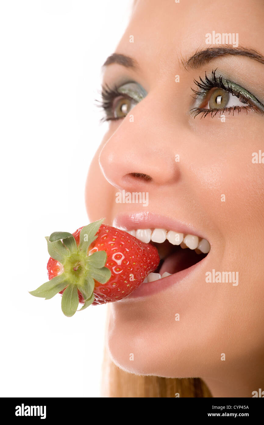 Beautiful girl eating strawberry Stock Photo - Alamy