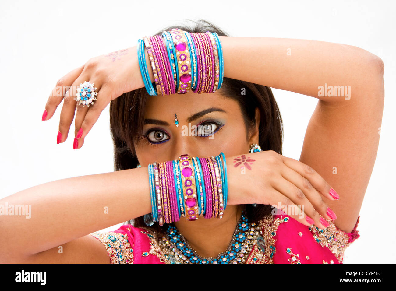 Beautiful face of a Bengali bride with her arms across her head covered ...