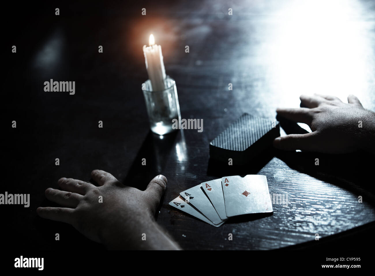 Human hands on a dark table with pack of cards and flaming candle Stock ...