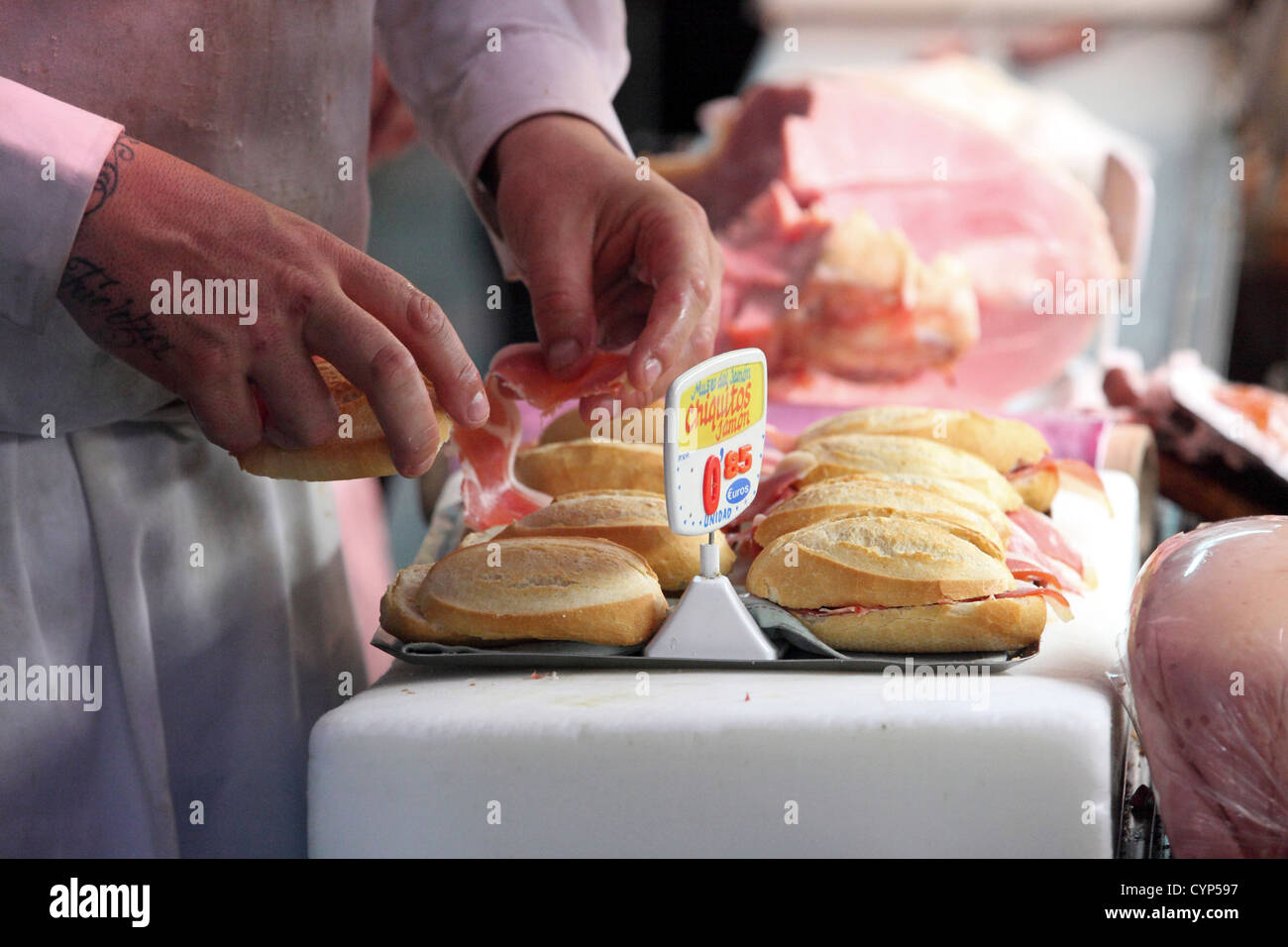 Shop assistant making ham jamon roll sandwich, Spanish Cafe, Madrid ...