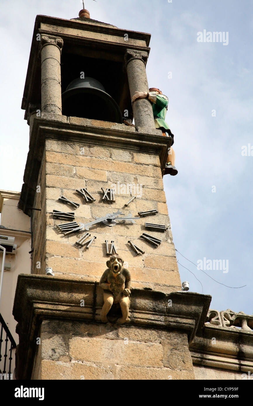 spanish bell tower with a statue screaming and a puppet hitting bell ...