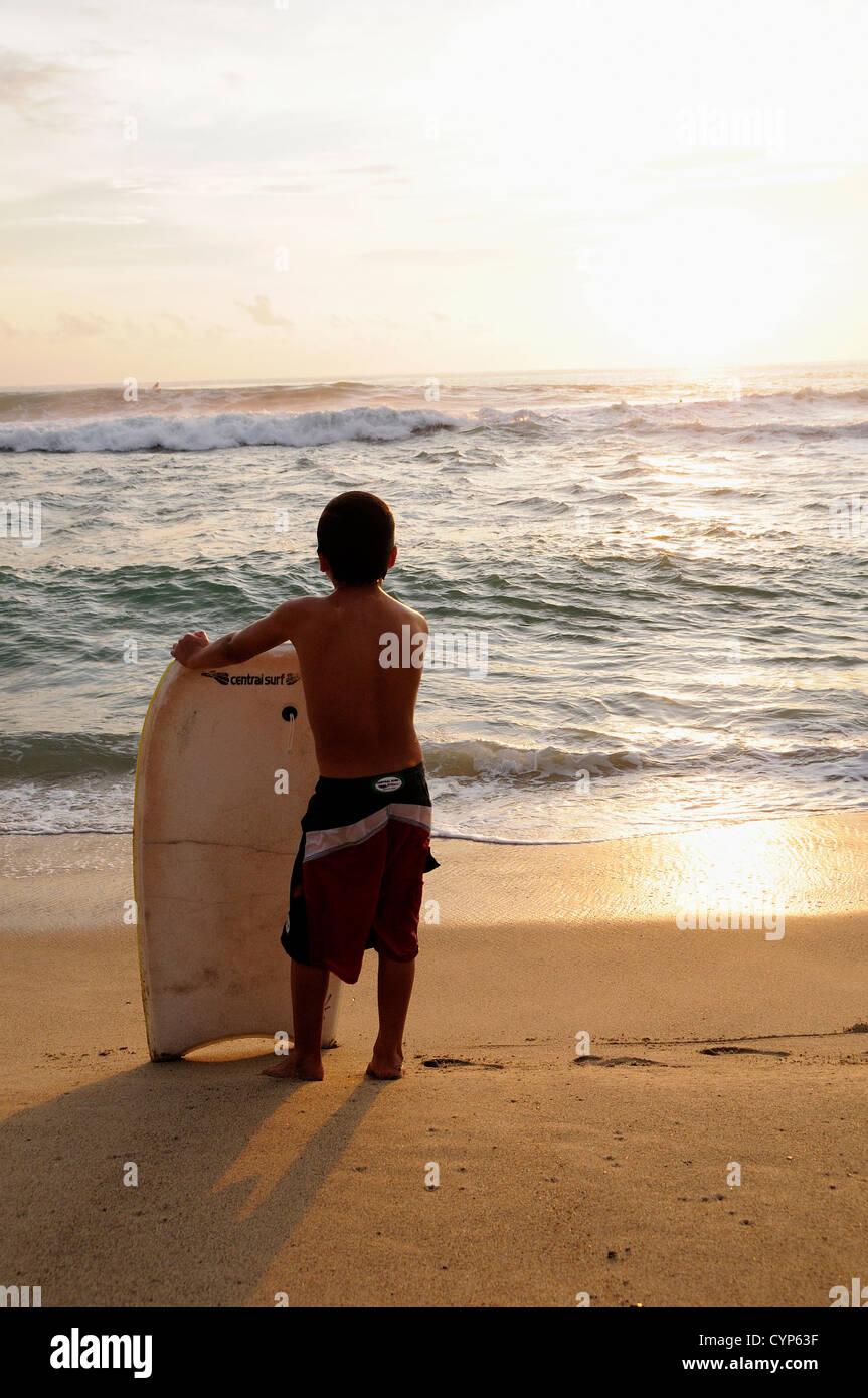 Playa Zicatela Young body boarder standing on beach looking out to sea ...