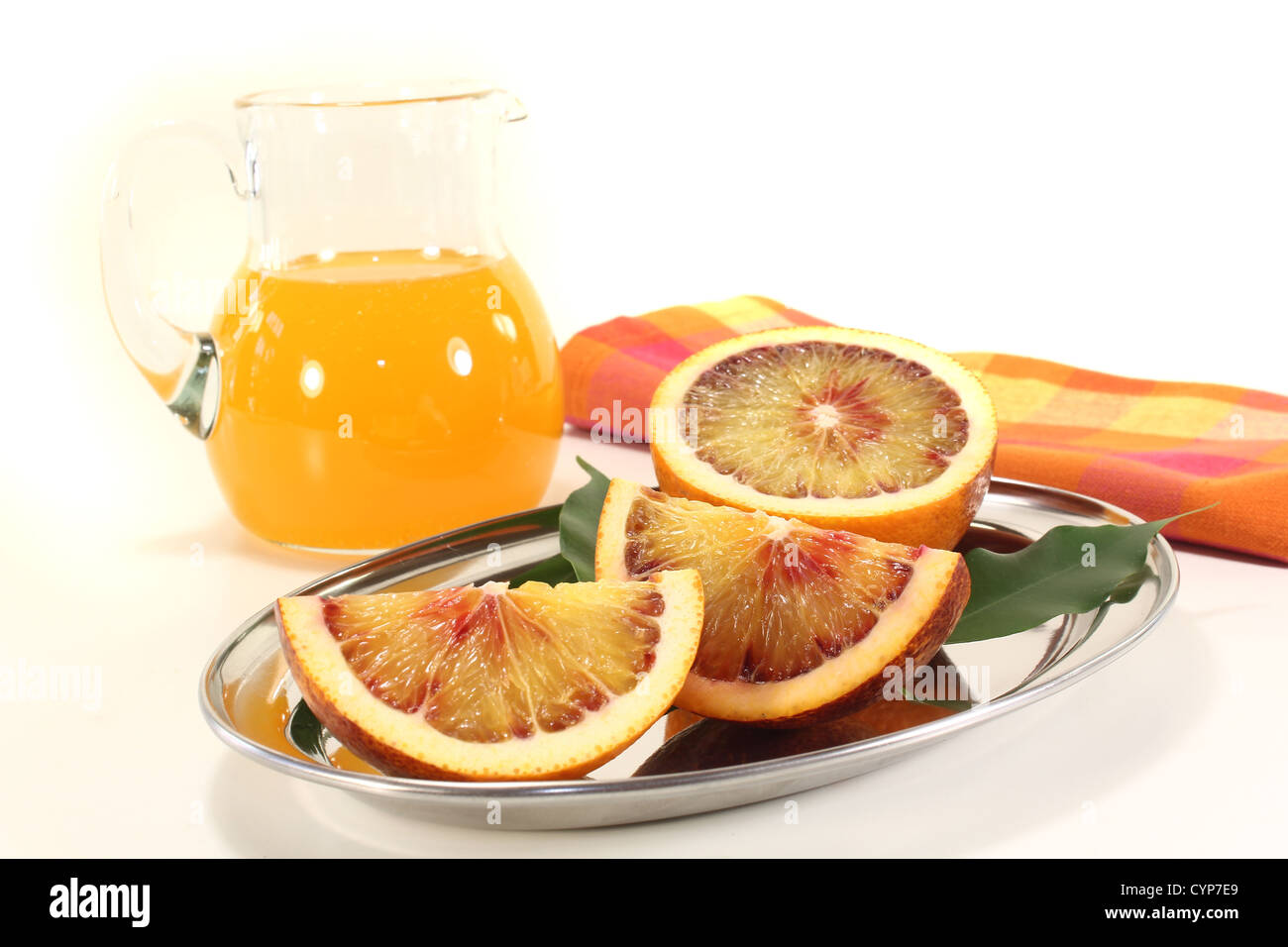 red-yellow blood orange with leaves and juice on a light background ...
