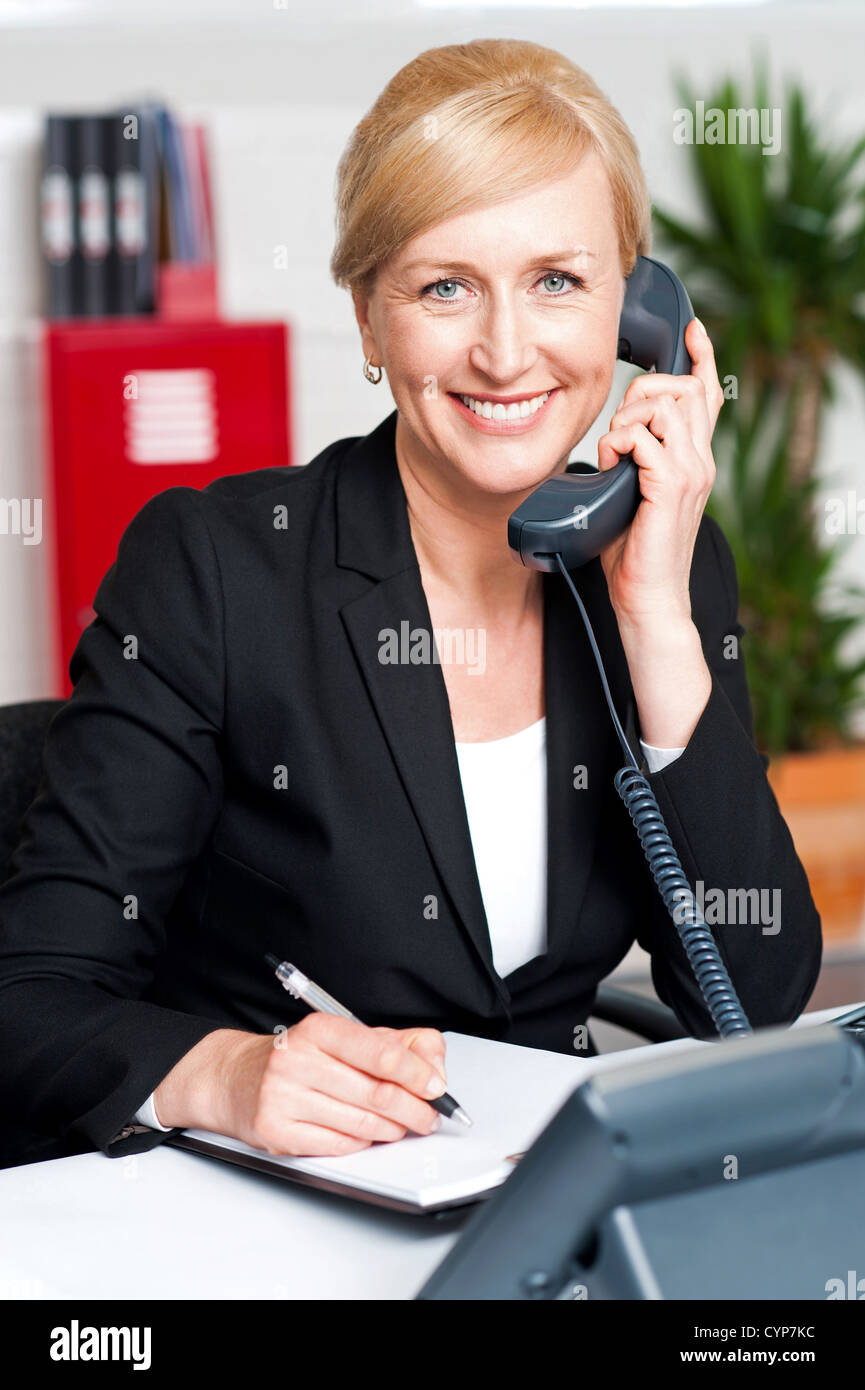 Corporate lady communicating on phone and confirming appointment Stock ...