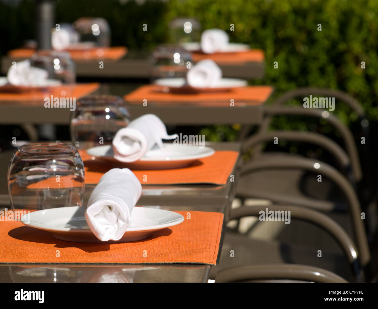 Restaurant set up tables on a sunny terrace Stock Photo - Alamy