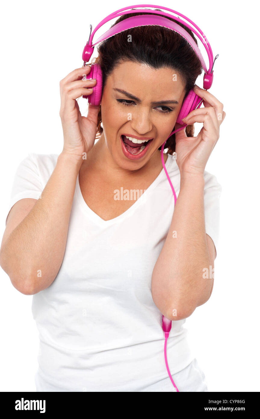 Brunette women enjoying rocking with loud music isolated over white ...