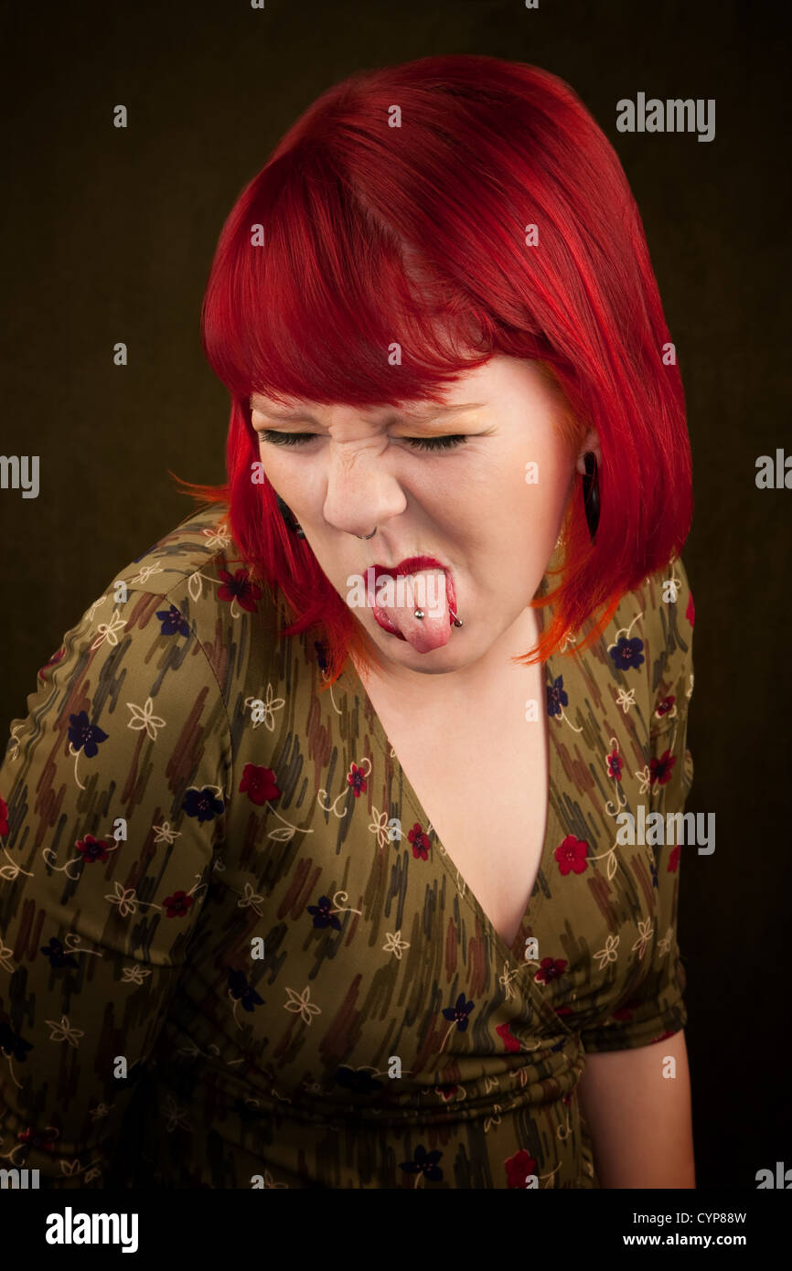 Pretty punky girl with brightly dyed red hair Stock Photo - Alamy