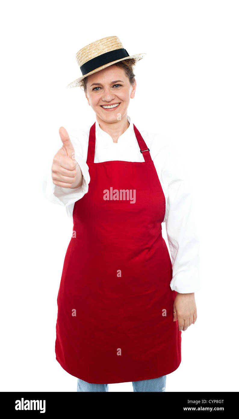 Lady chef in hat with thumbs up gesture in front of camera Stock Photo ...