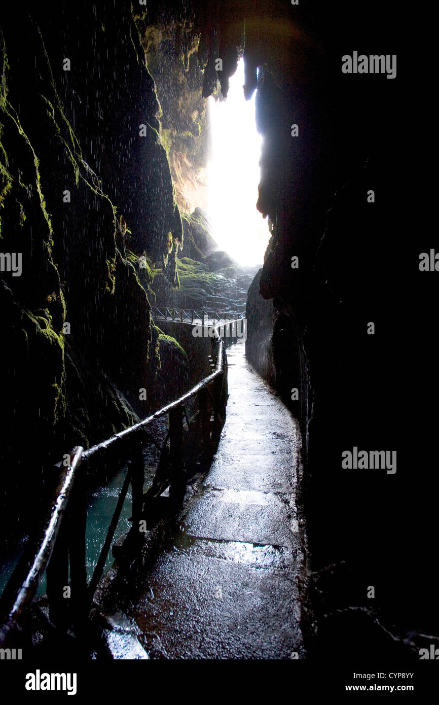 stone path inside a grot with a wood balustrade and raining Stock Photo ...