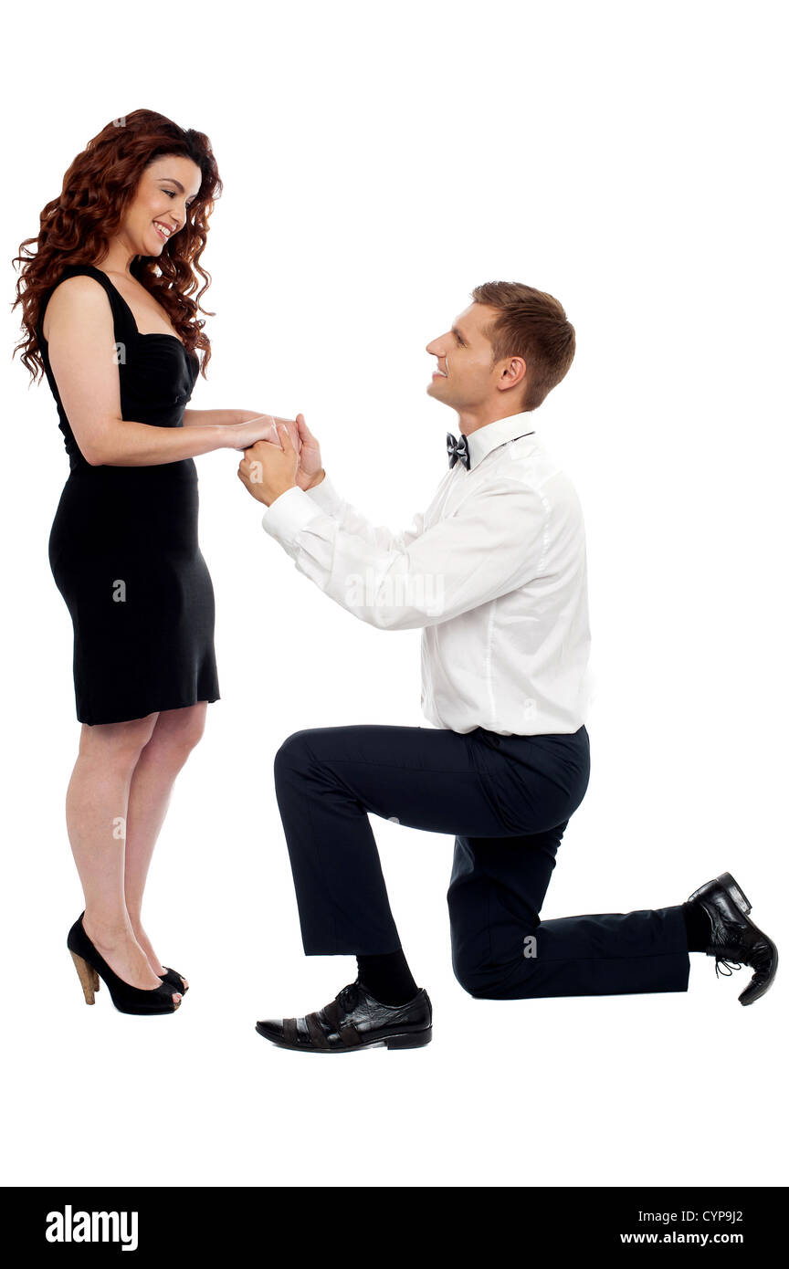 Handsome guy on knees proposing girl. Will you marry me Stock Photo - Alamy