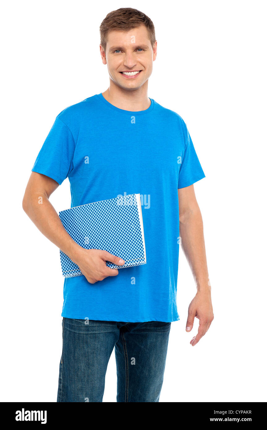 Smiling guy holding spiral notebook isolated over white background ...