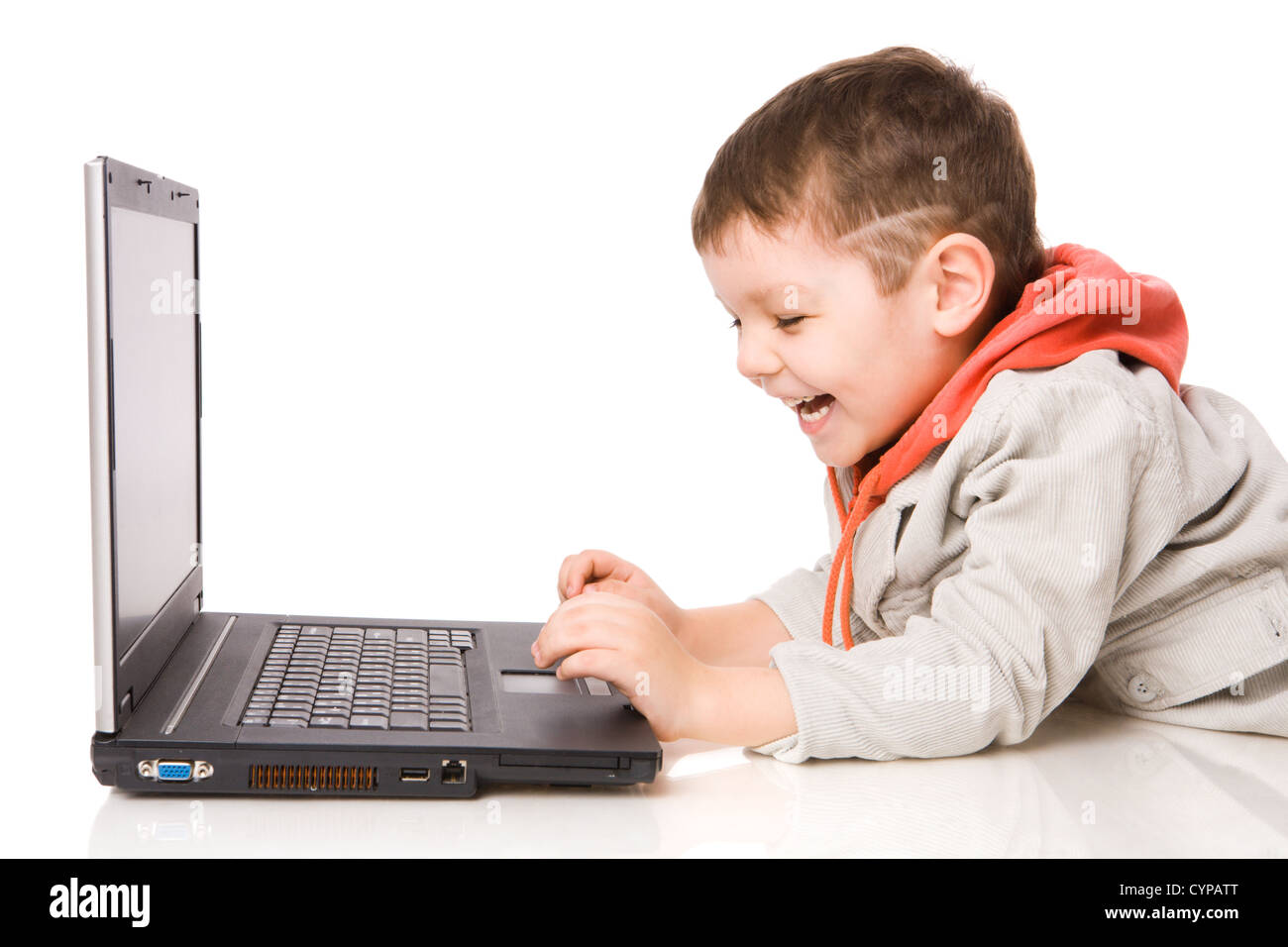 Boy typing on laptop and laughing isolated on white Stock Photo - Alamy