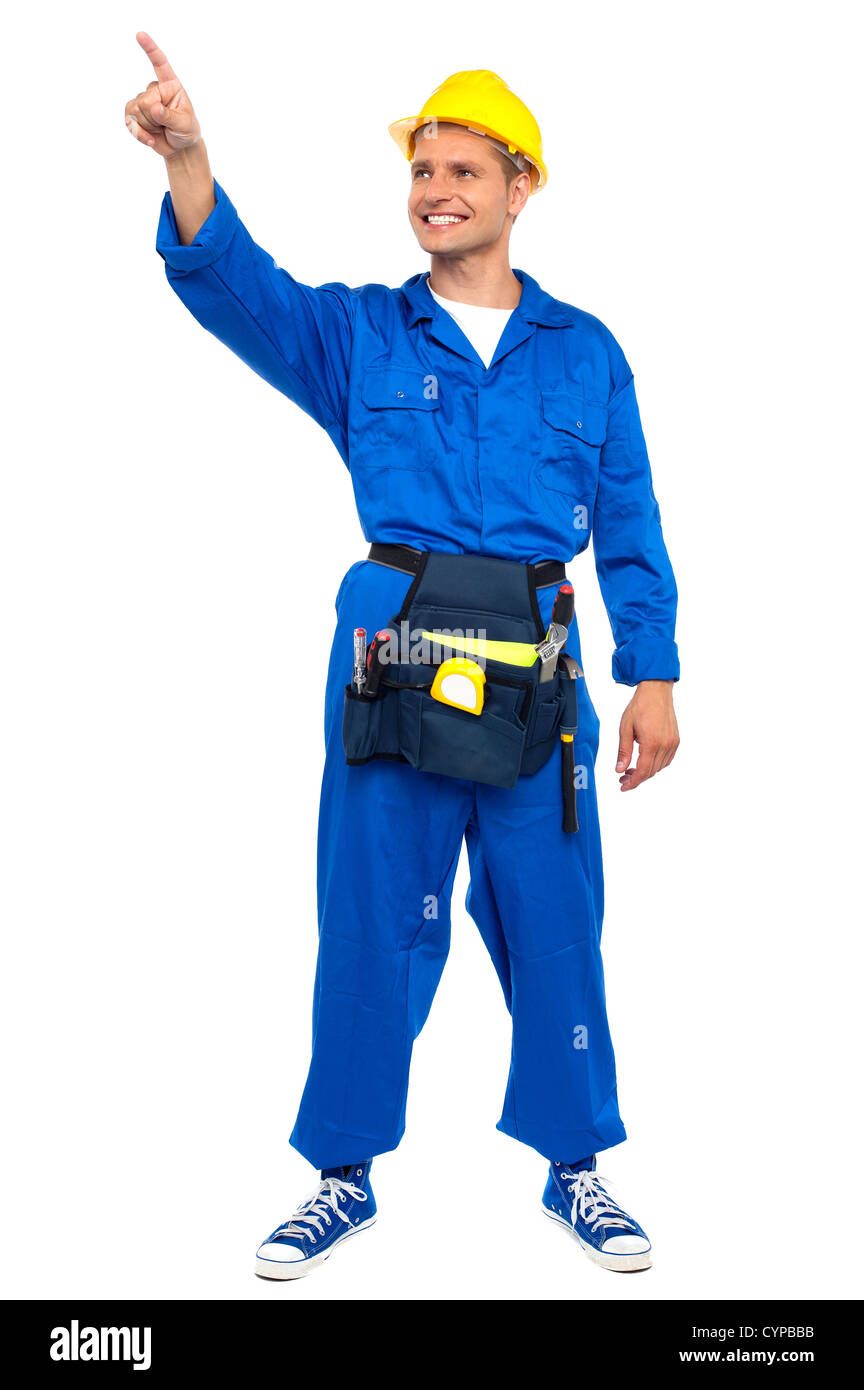 Construction worker pointing at copy space area. Full length portrait ...