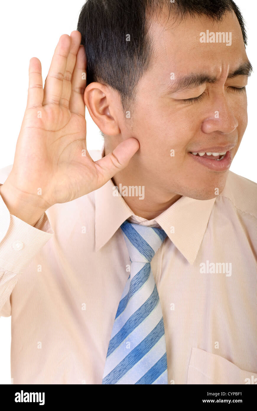 Businessman listen by gesture with his hand to ear to hear on white ...