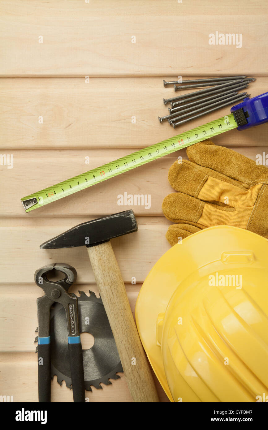 Working tools on a wooden boards background. Including saw, ruler ...