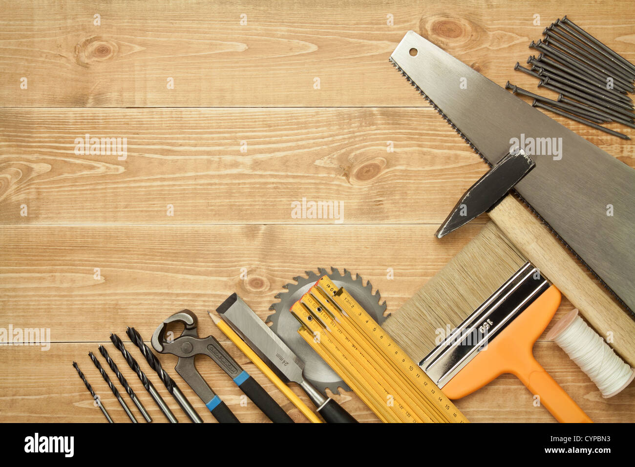 Working tools on a wooden boards background. Including saw, ruler ...