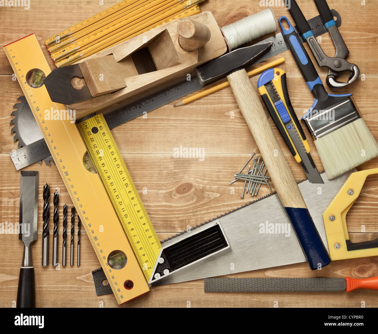 Working tools on a wooden boards background. Including saw, ruler ...
