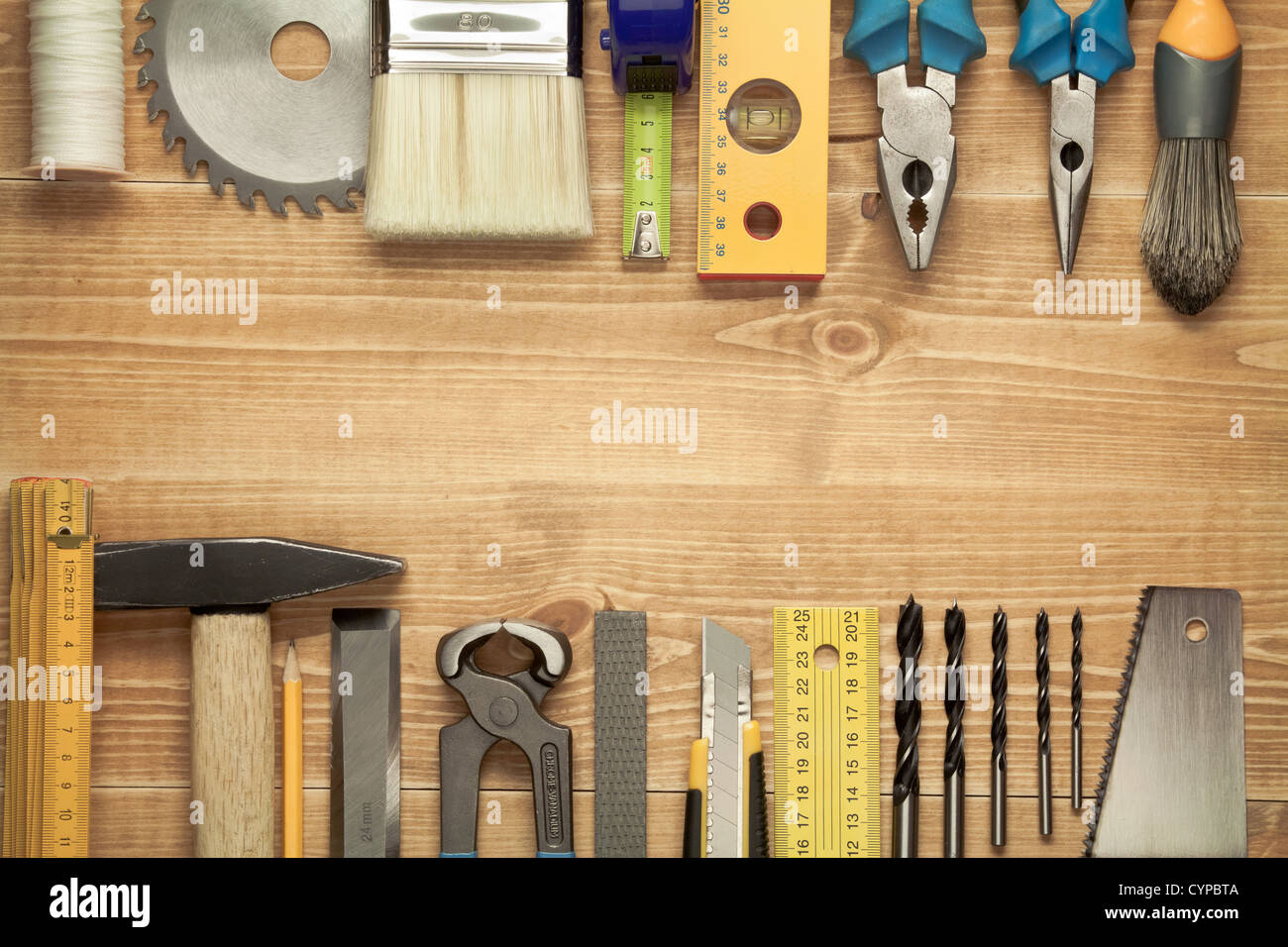 Working tools on a wooden boards background. Including saw, ruler ...