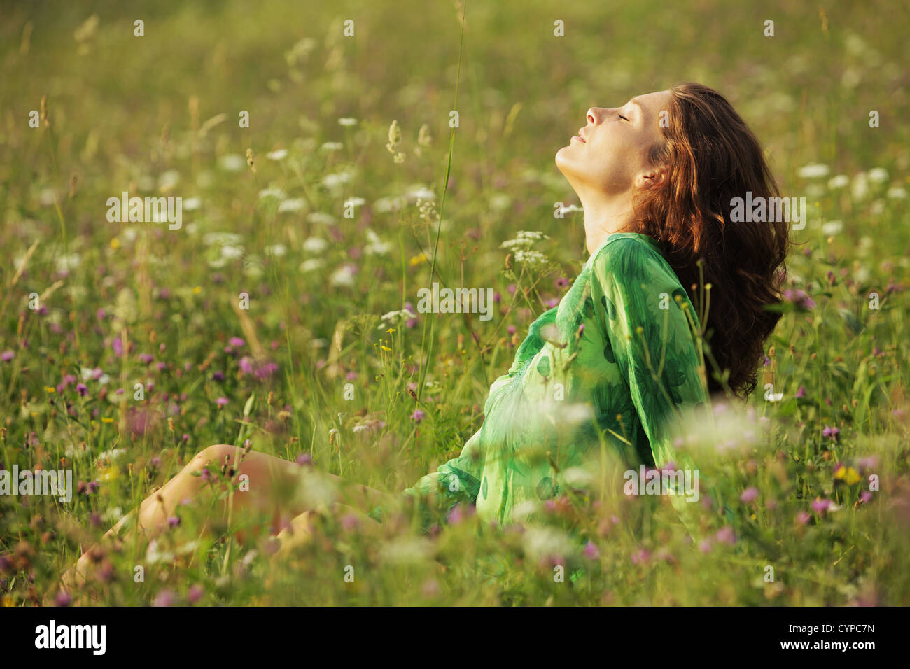 Young beautiful woman enjoying nature in the flowers field Stock Photo ...