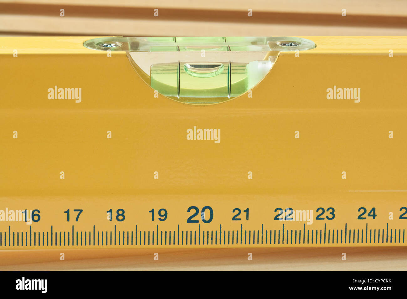 Yellow level tool on wood plank Stock Photo - Alamy