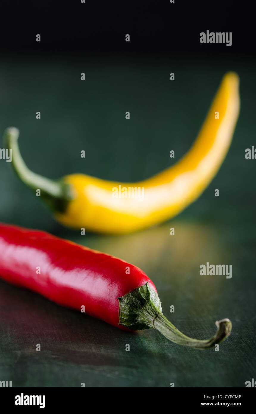 a red and a yellow chilli Stock Photo - Alamy
