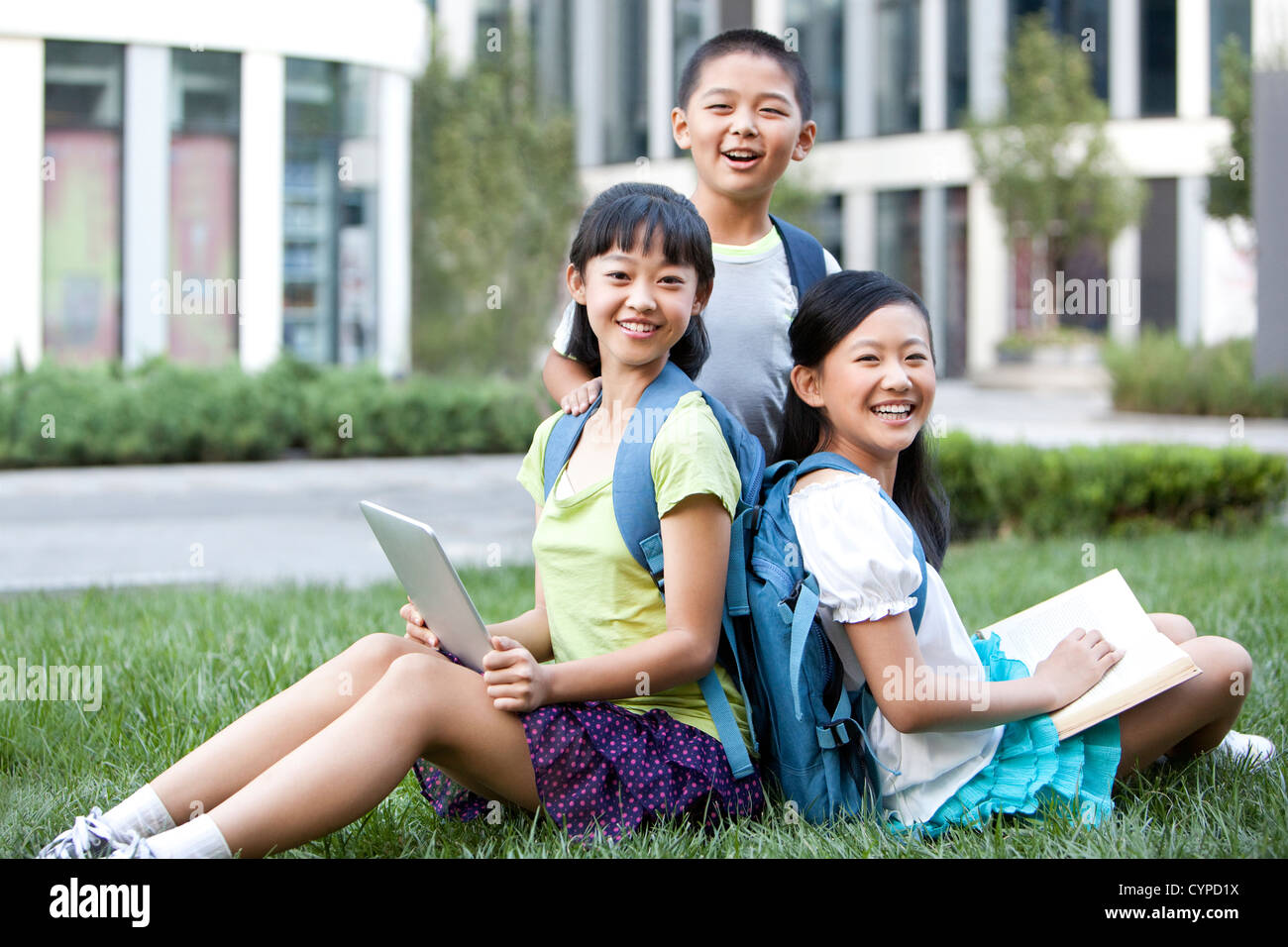 Schoolchildren learning with books and digital tablet Stock Photo - Alamy