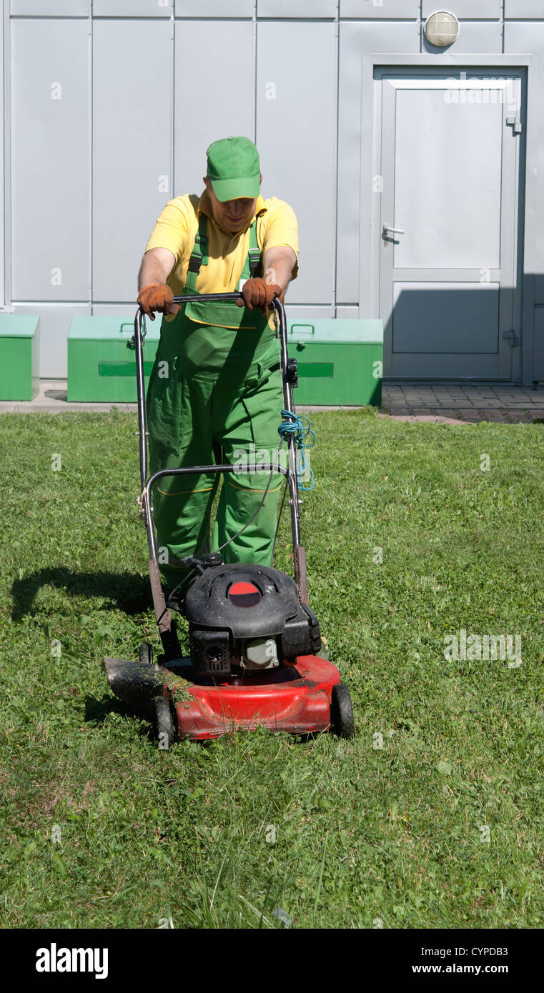 lawn mower man working on the backyard Stock Photo - Alamy
