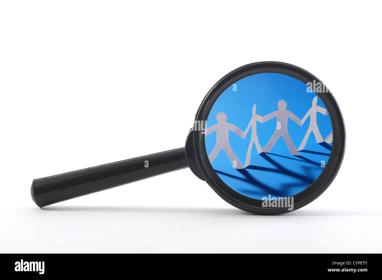 magnifying glass and team of paper man showing teamwork Stock Photo - Alamy
