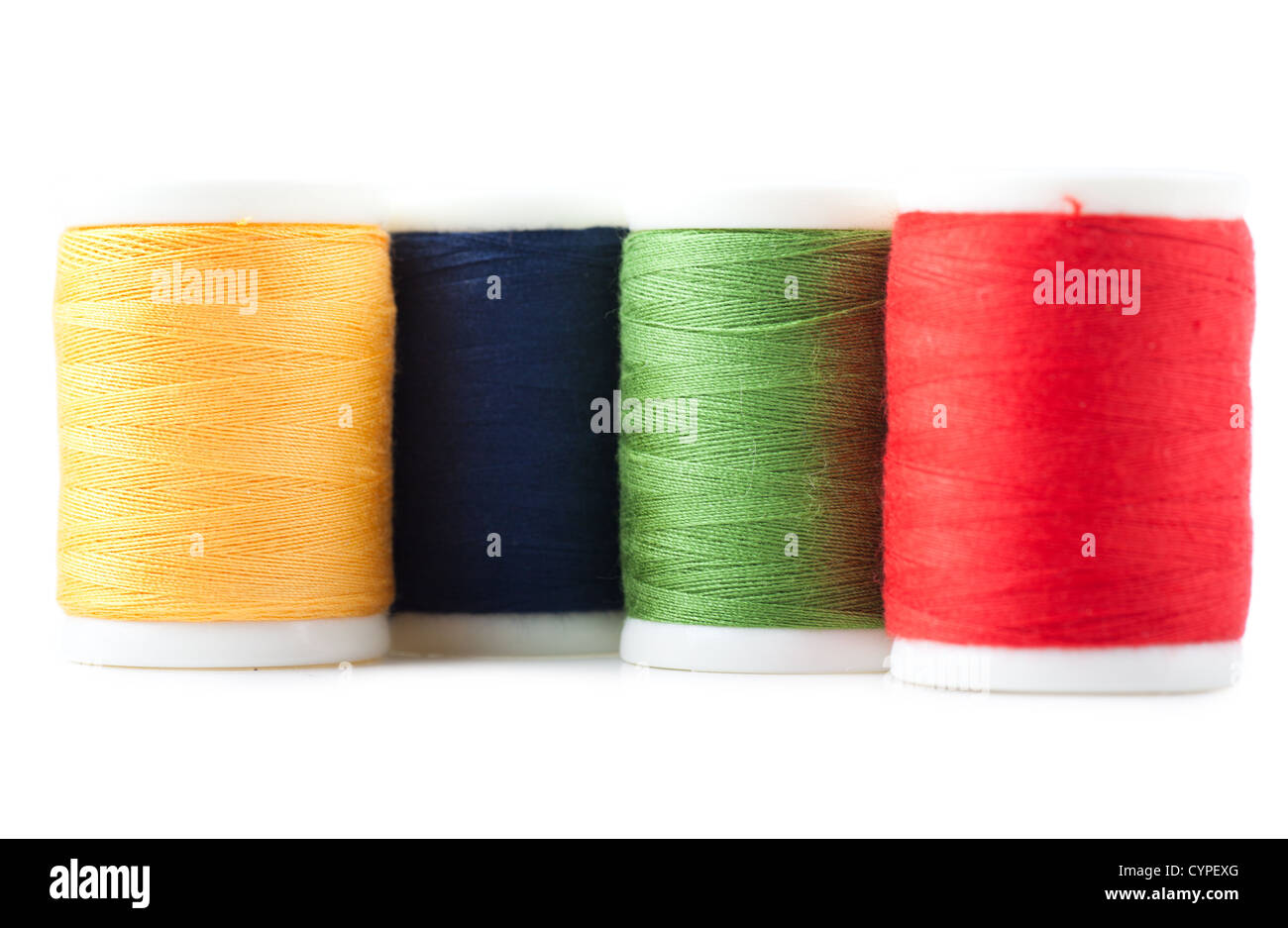 Four spools with green, yellow, blue and red threads Stock Photo - Alamy