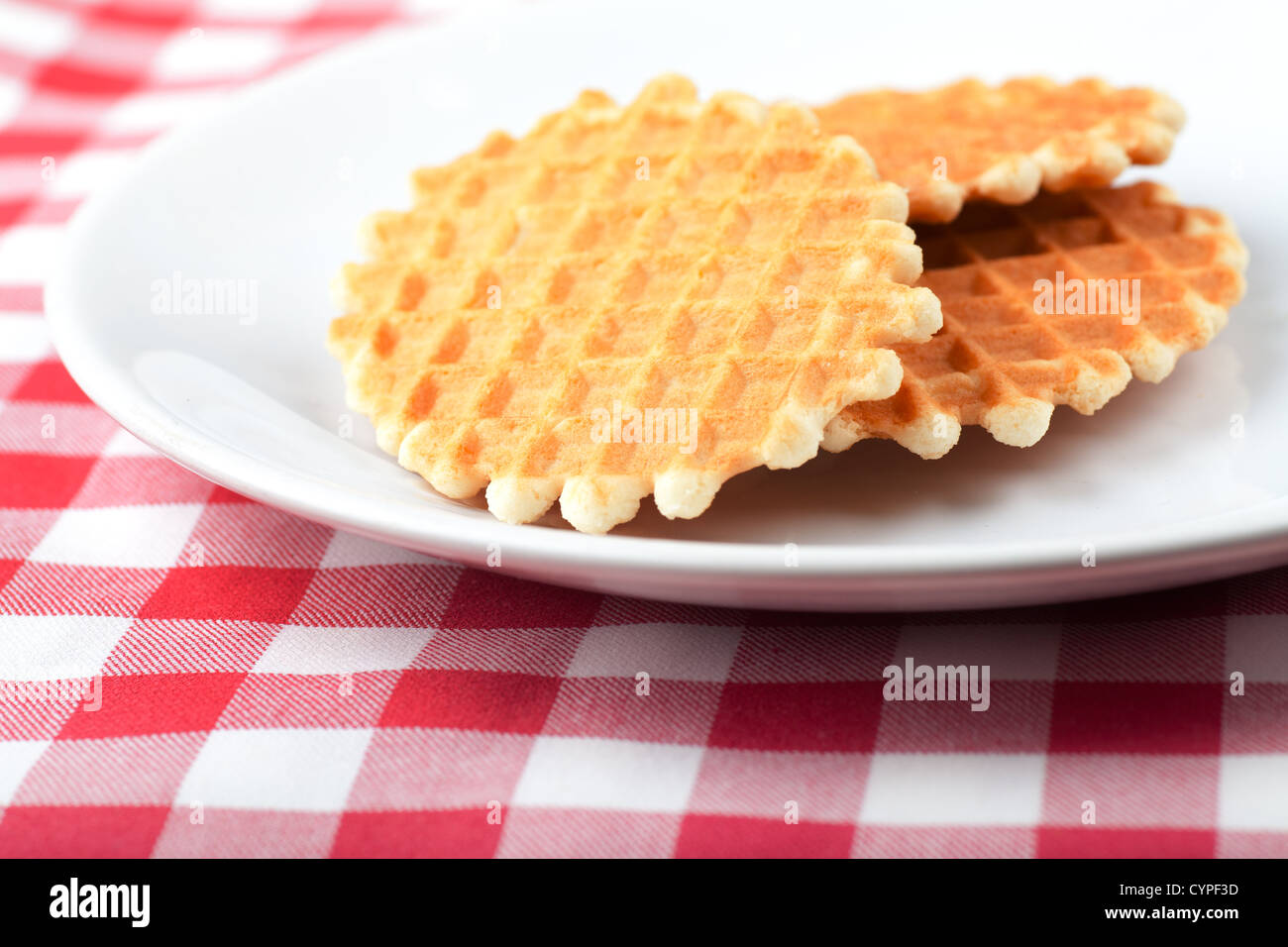 Three golden round waffles on a white plate Stock Photo - Alamy