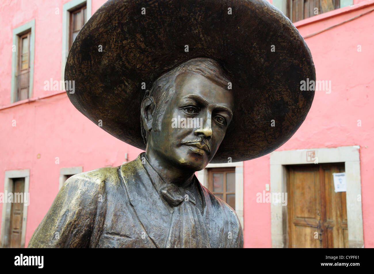 Bronze statue of Charro singer Jorge Negrete with pink painted building ...