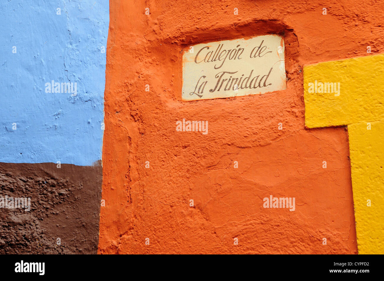 Street sign and brightly painted exterior walls of buildings American ...