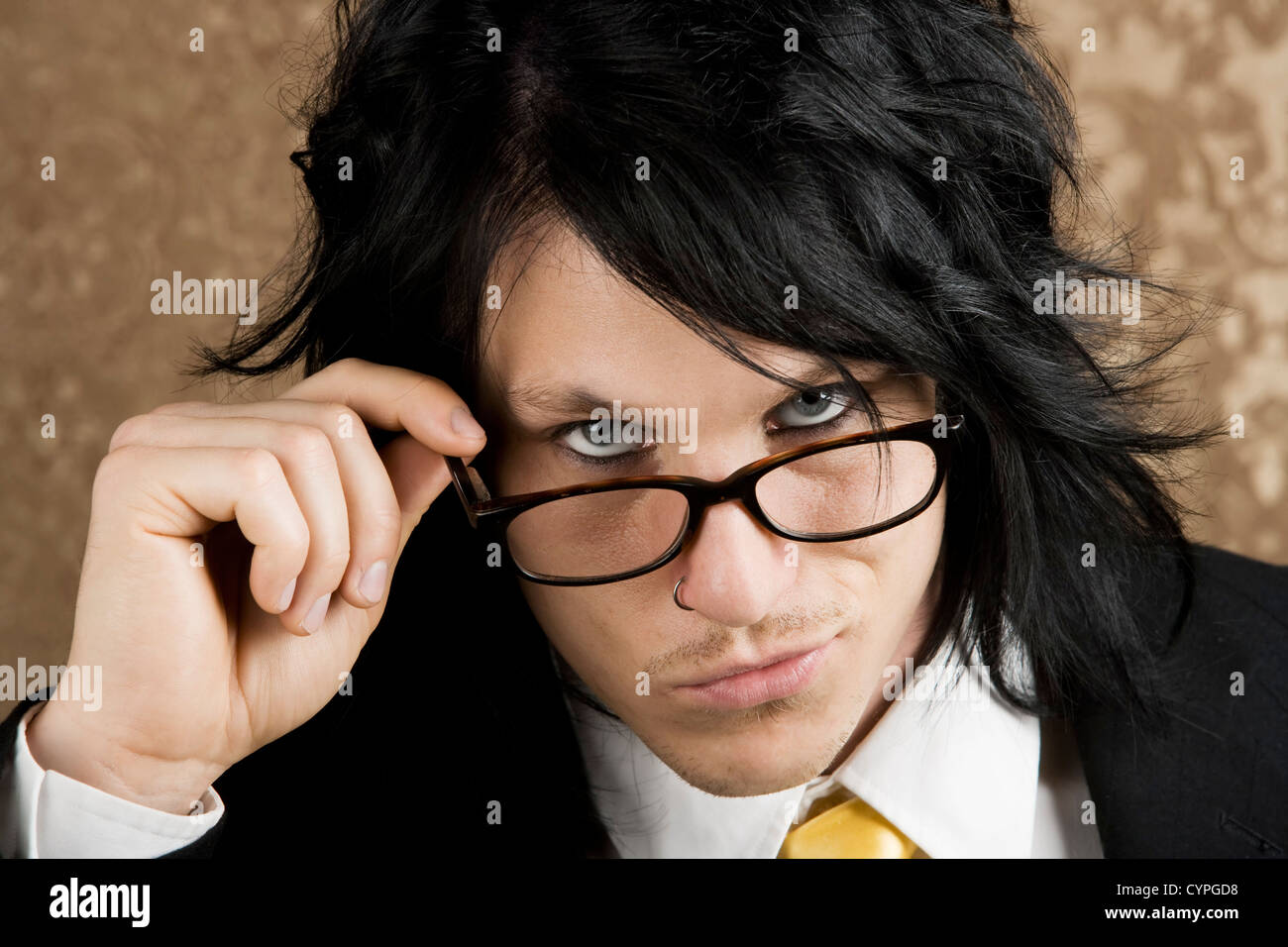 Handsome Young Man Looking Over the Top of his Glasses Stock Photo - Alamy