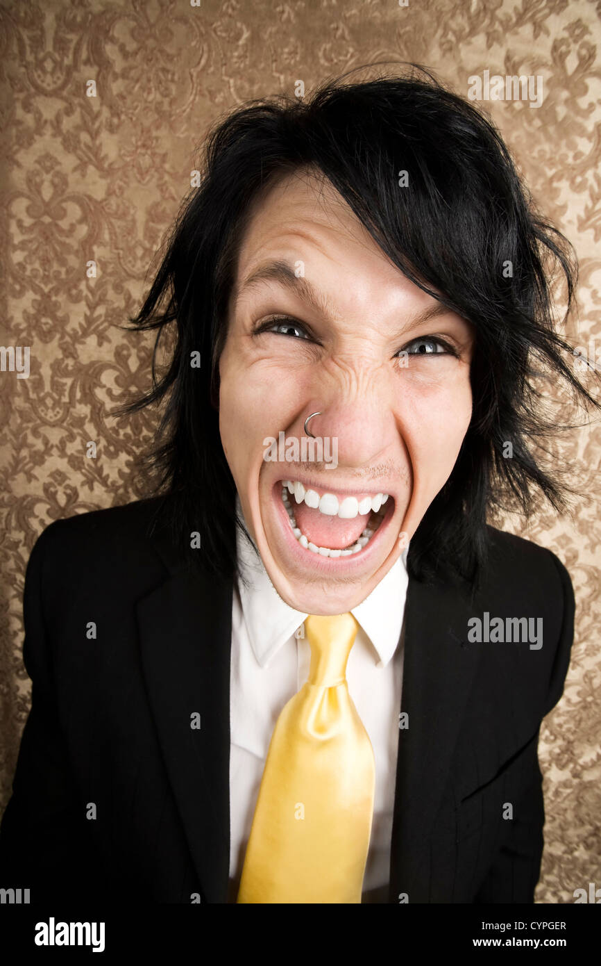 Screaming young man in a business suit and tie Stock Photo - Alamy