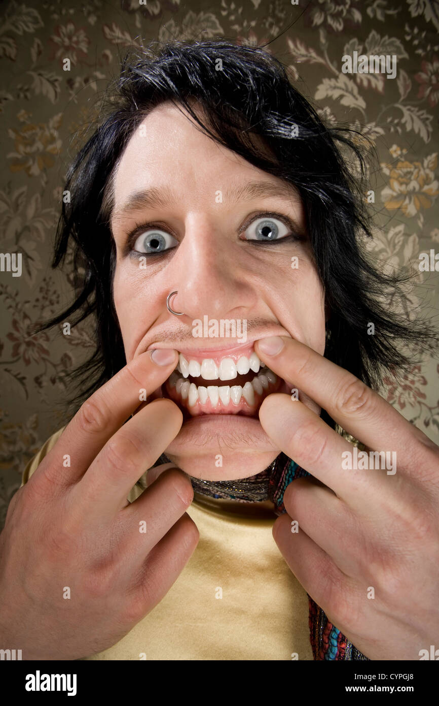 Man stretching his mouth to make a funny face Stock Photo - Alamy