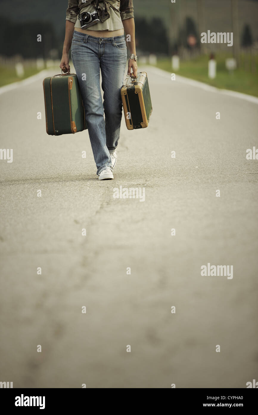 Young woman runaway walks away road. Copy space Stock Photo - Alamy