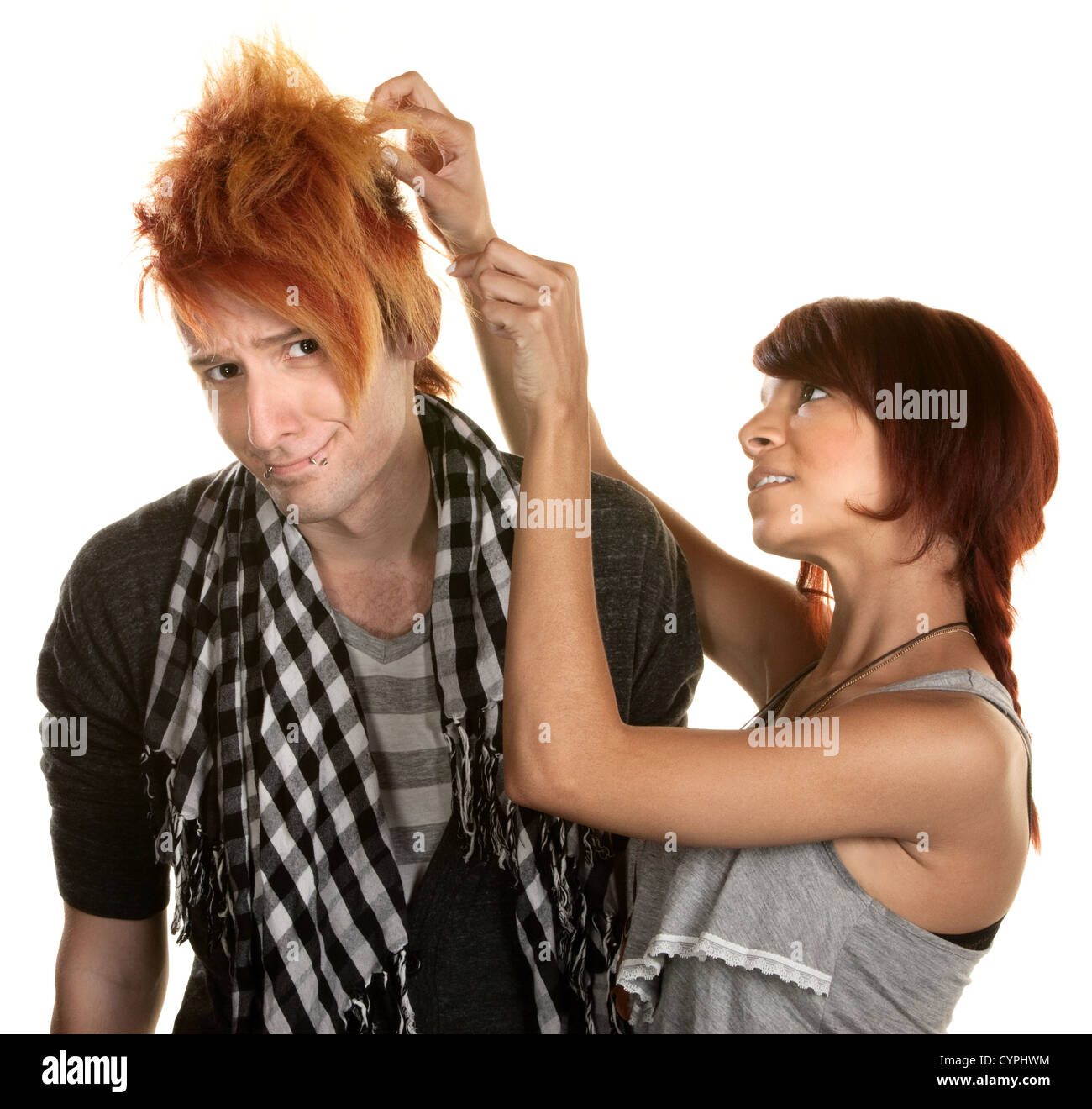 Cute young woman picking at her friends hair Stock Photo - Alamy