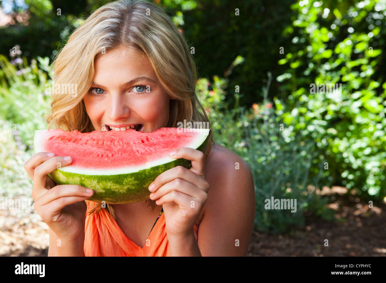 Caucasian girl eating watermelon Stock Photo - Alamy