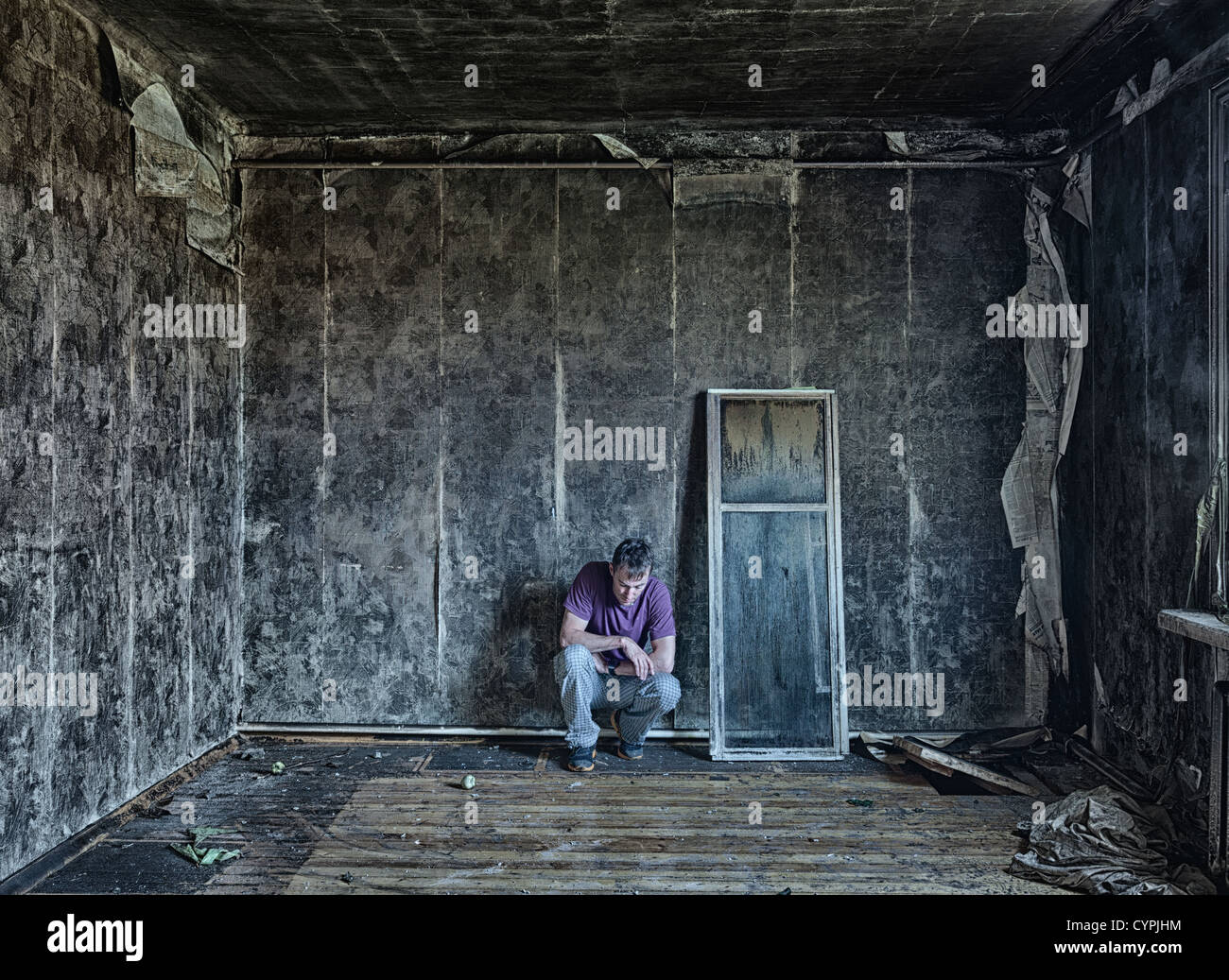 sad man, sitting in burnt room Stock Photo - Alamy