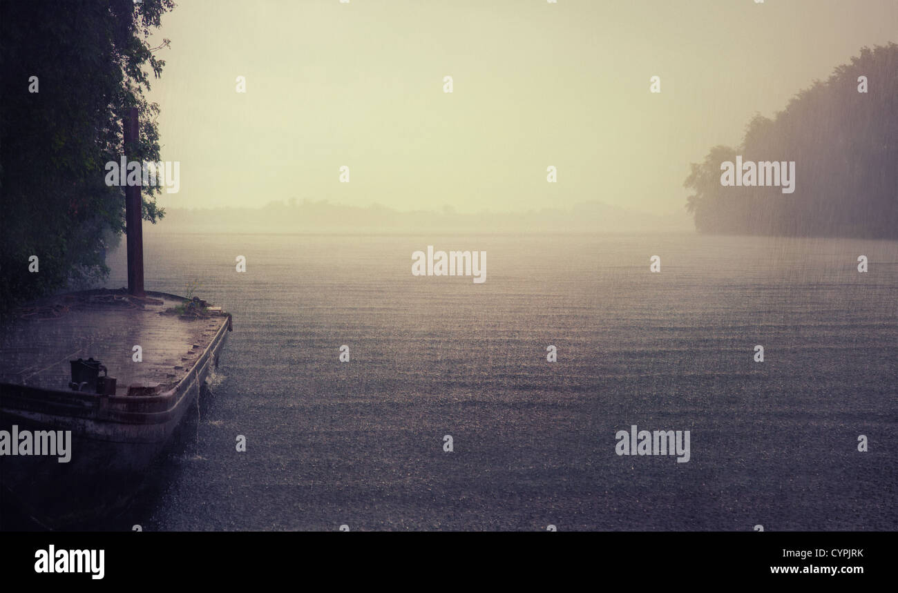 rain on the lake and old boat photo Stock Photo - Alamy