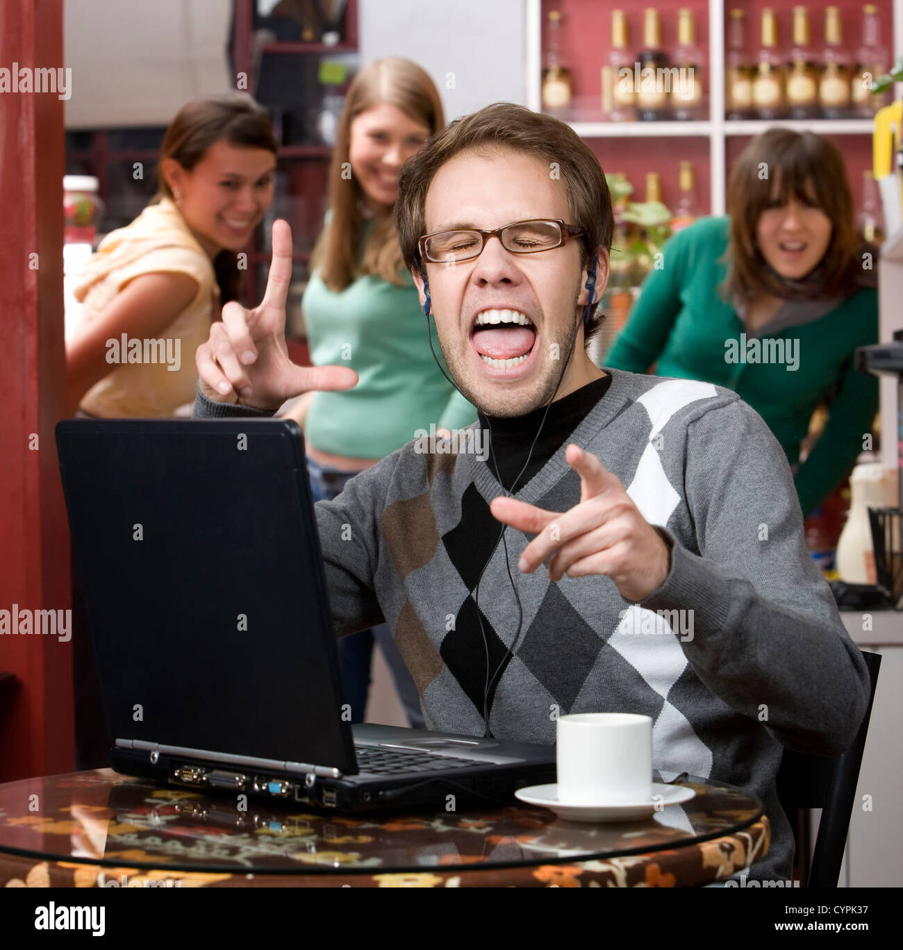 Obnoxious young man singing loudly in a coffee house Stock Photo - Alamy