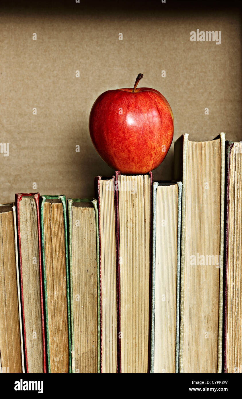 Apple on top of books Stock Photo - Alamy